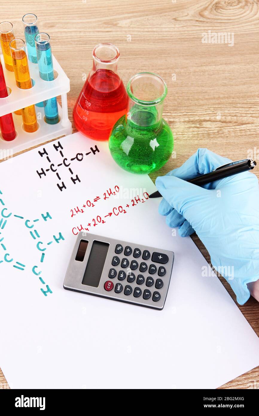 Hand scientist writing formulas Stock Photo - Alamy