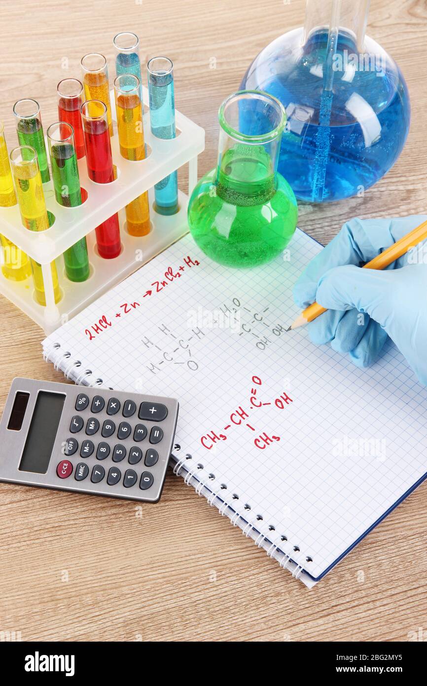 Hand scientist writing formulas Stock Photo - Alamy