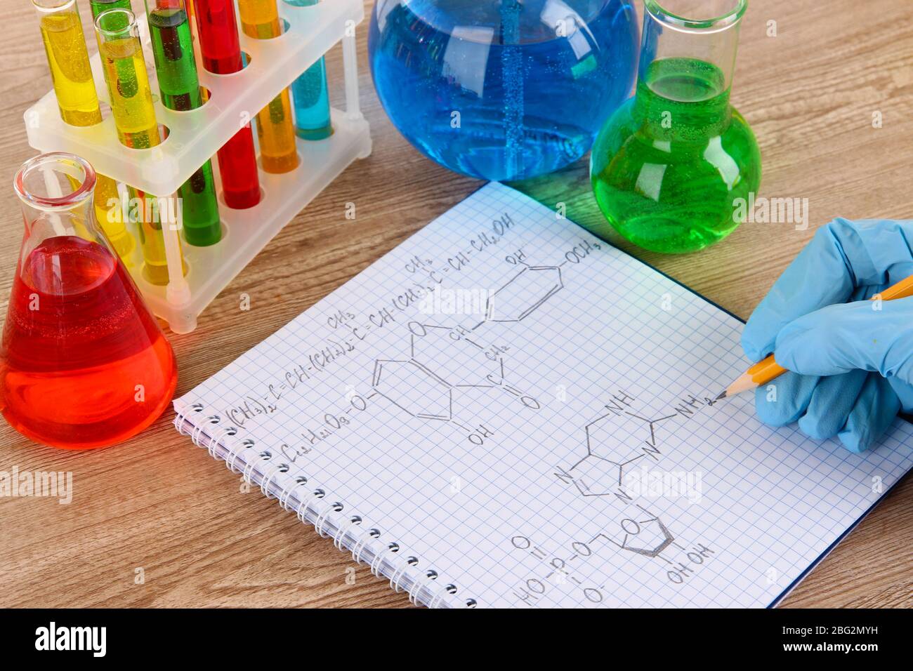 Hand scientist writing formulas Stock Photo - Alamy