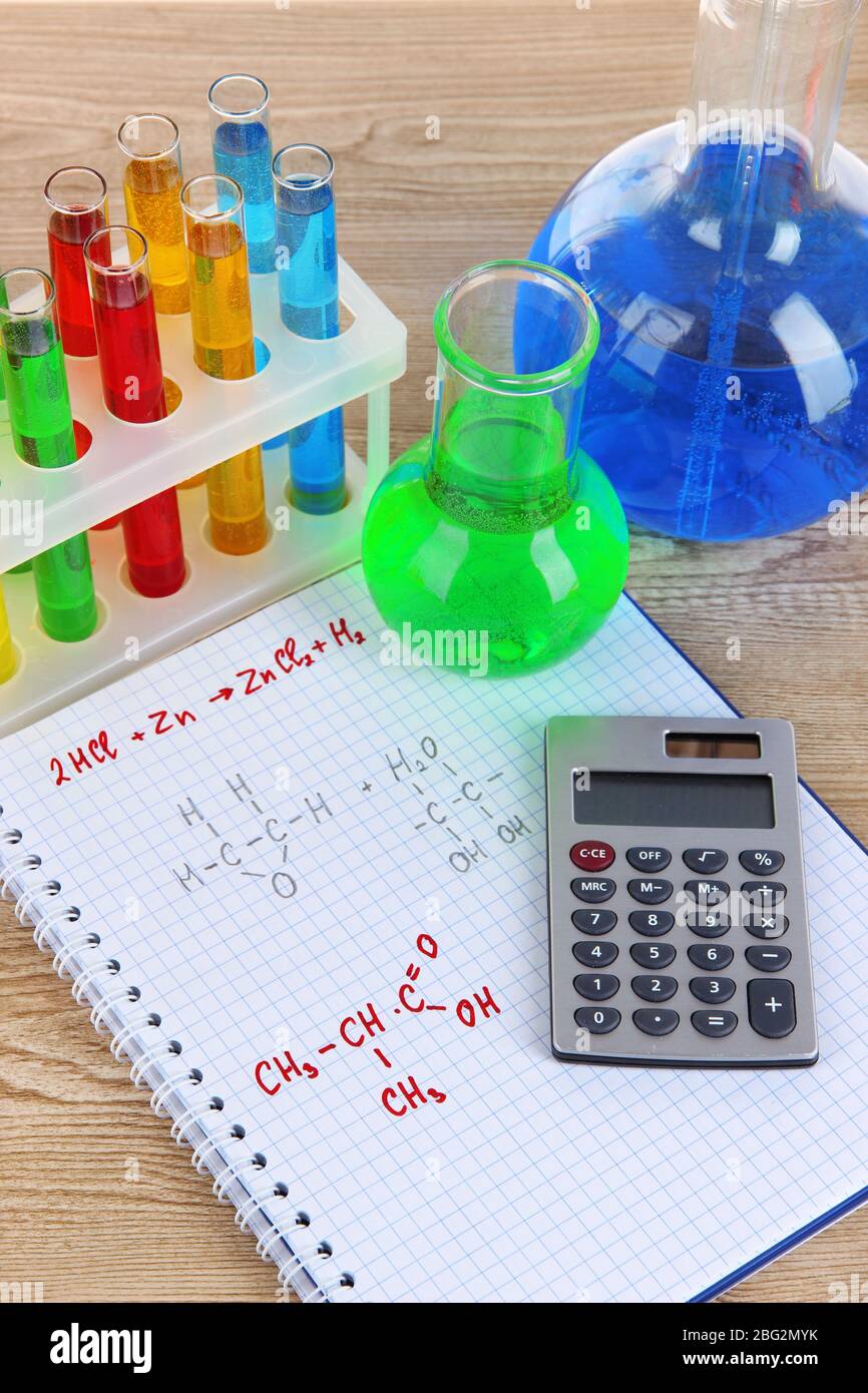 Test tubes with colorful liquids and formulas on table Stock Photo - Alamy