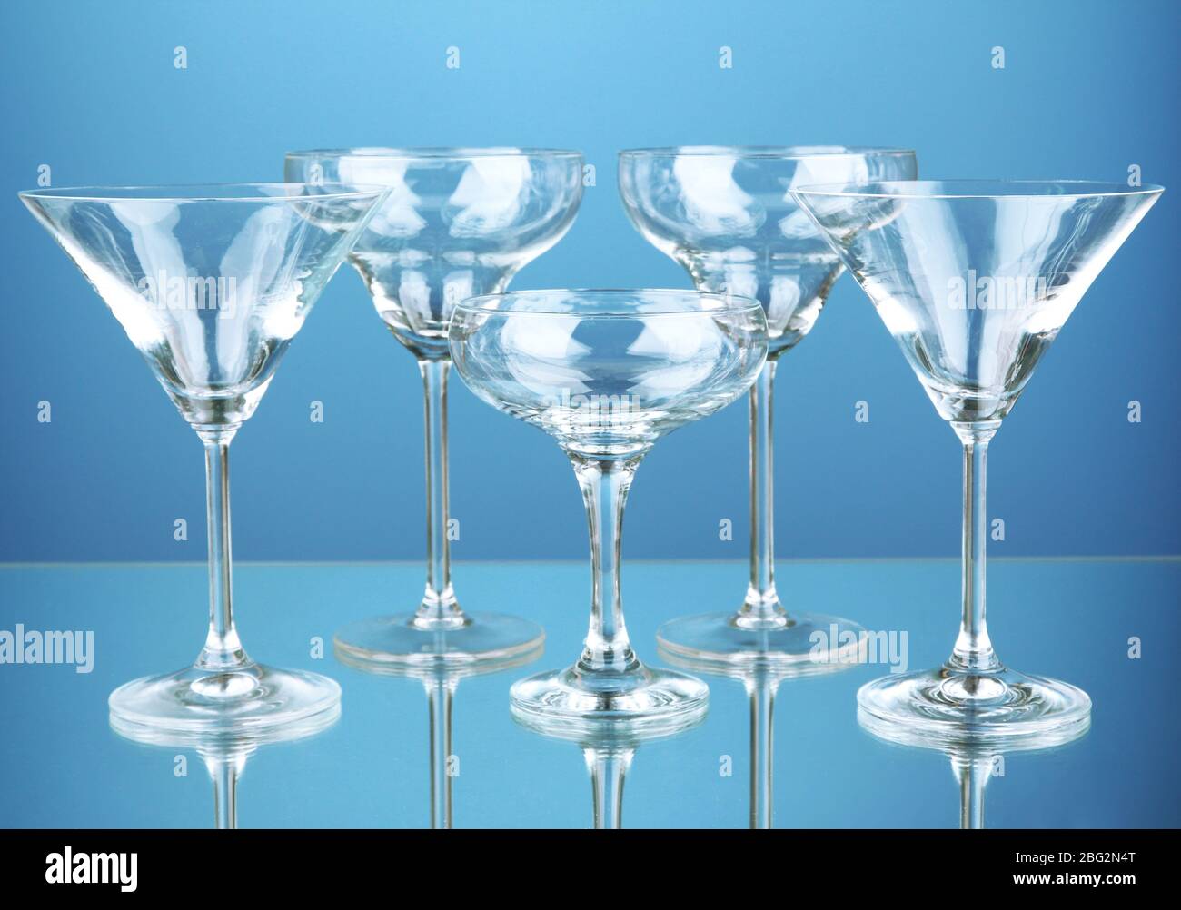 Cocktail glass set on blue background Stock Photo - Alamy