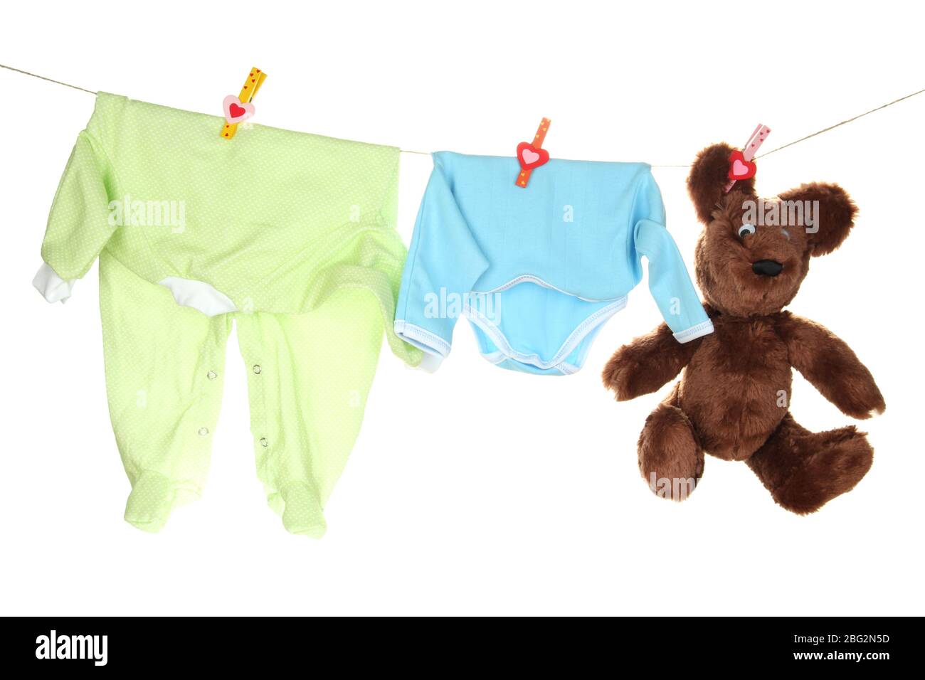 Baby clothes hanging on clothesline, isolated on white Stock Photo - Alamy