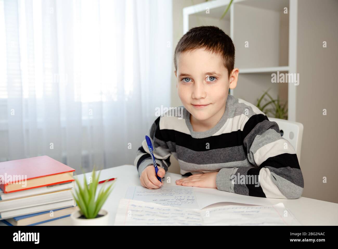 Cute boy is doing math homework. Stay at home. Stay safe. Coronavirus ...
