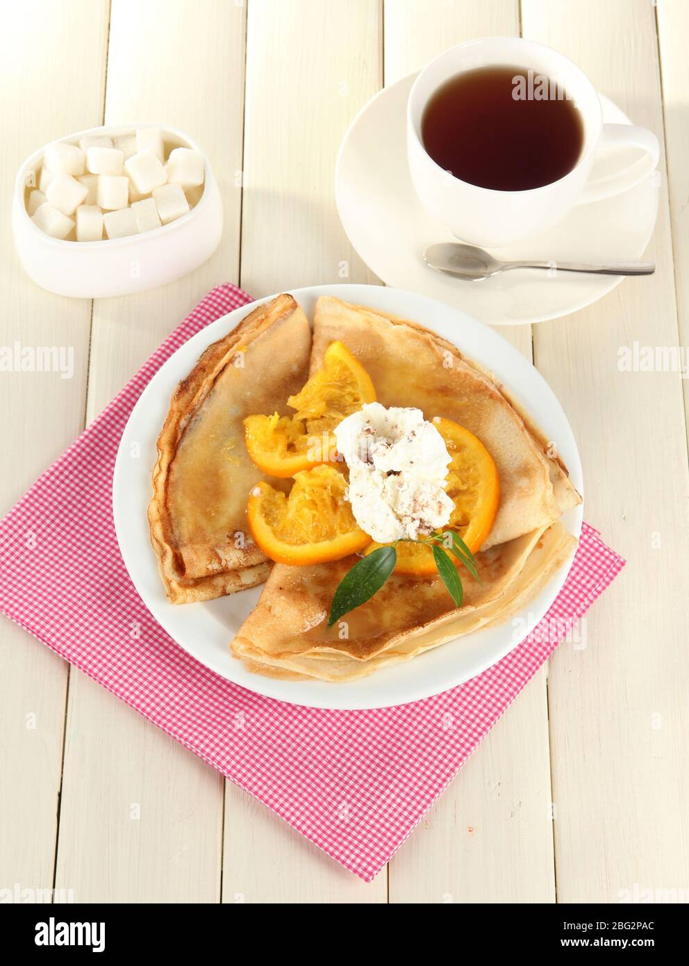 Pancakes with orange on wooden table Stock Photo - Alamy