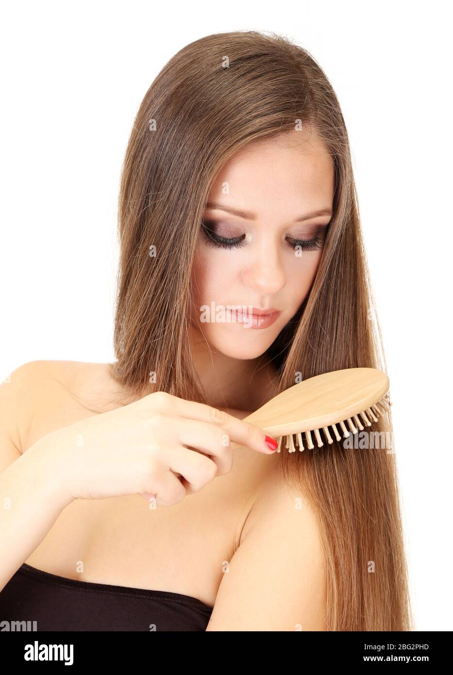 Woman brushing long dark hair with hairbrush hi-res stock photography ...