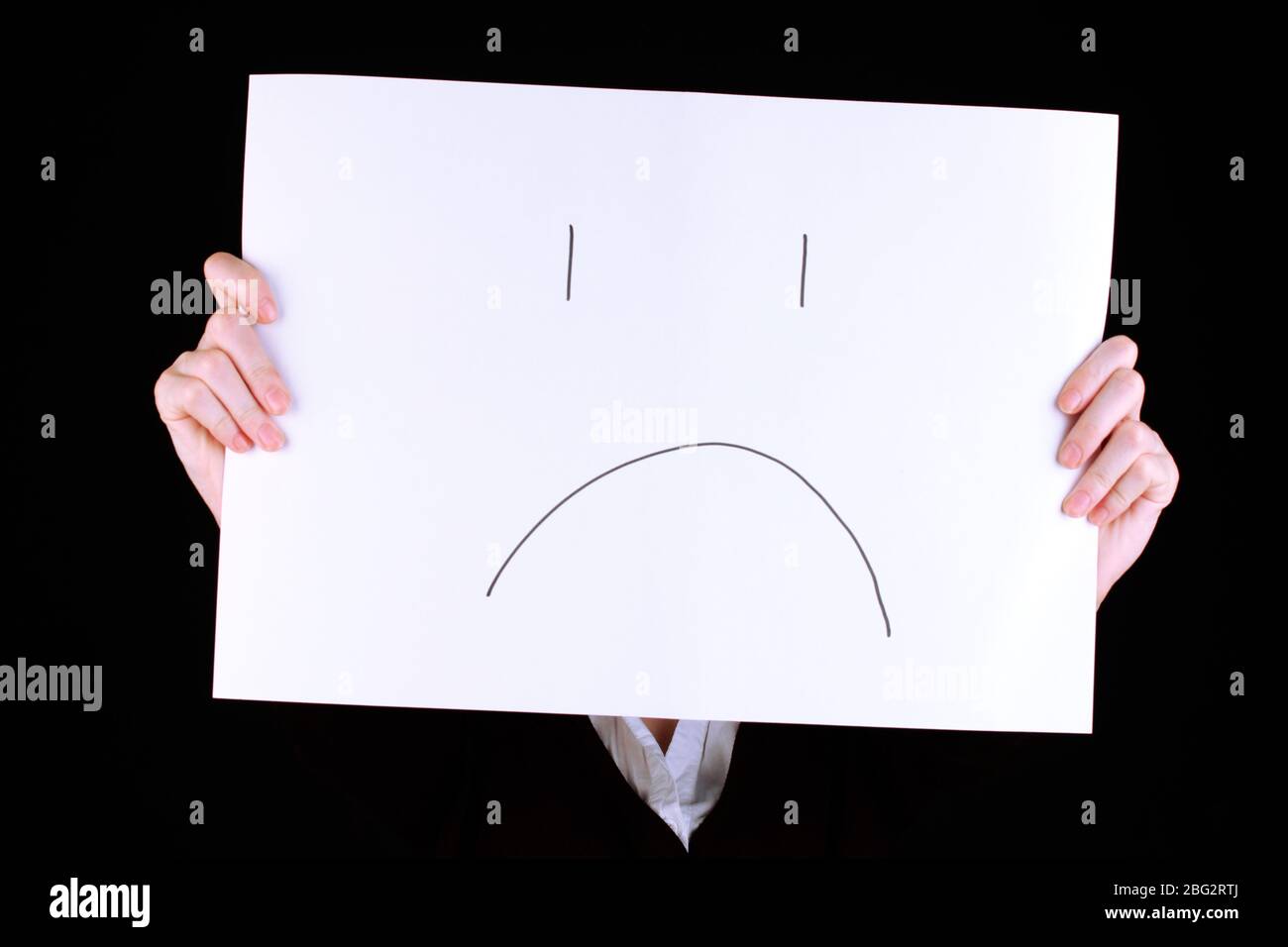 Woman holding paper with sad emoticon, isolated on black Stock Photo ...