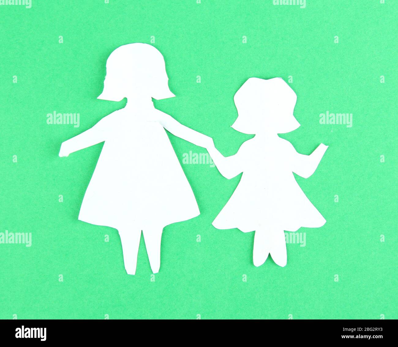 Paper people on color background Stock Photo - Alamy