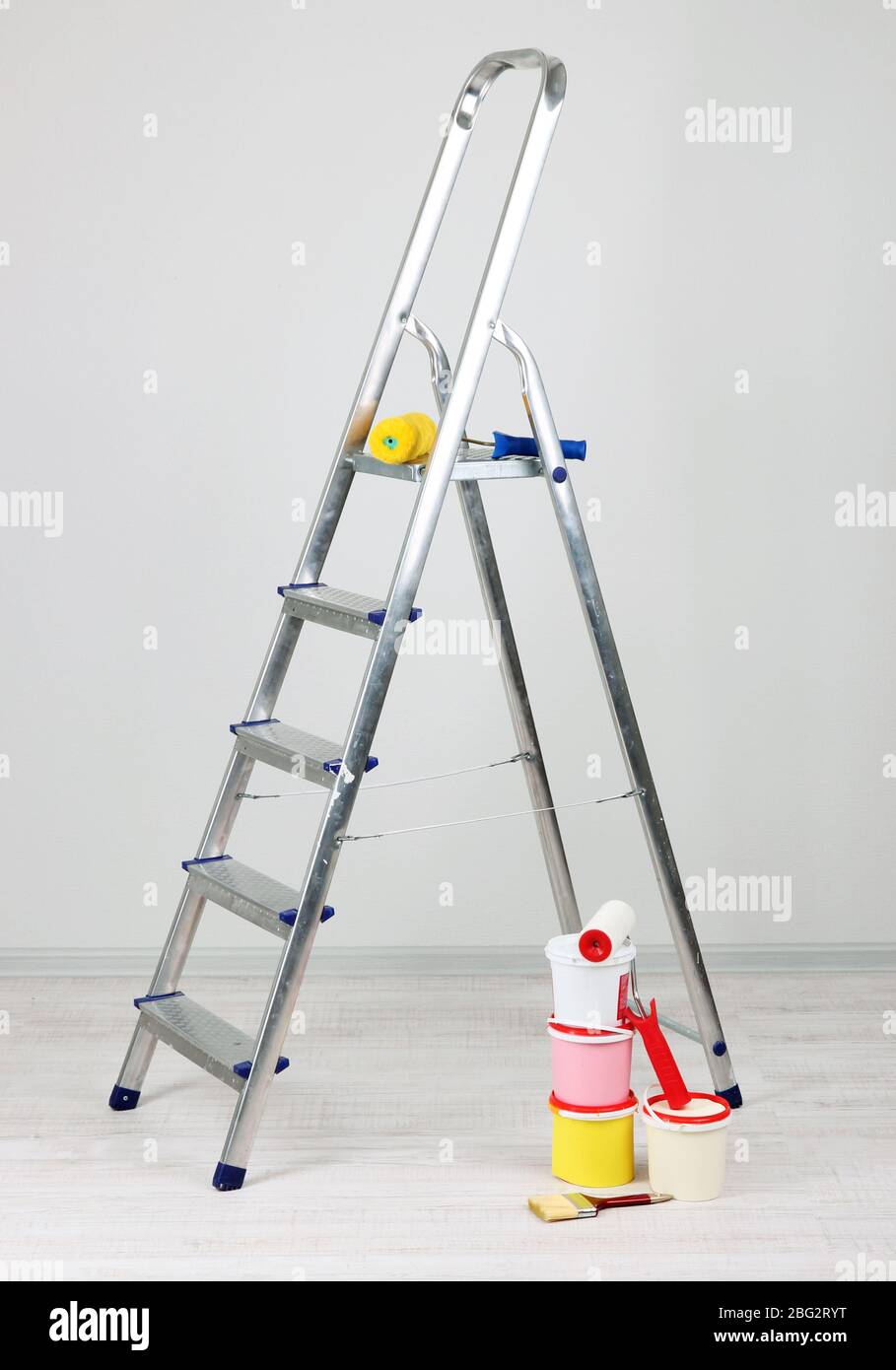 Metal ladder and paint in room Stock Photo - Alamy