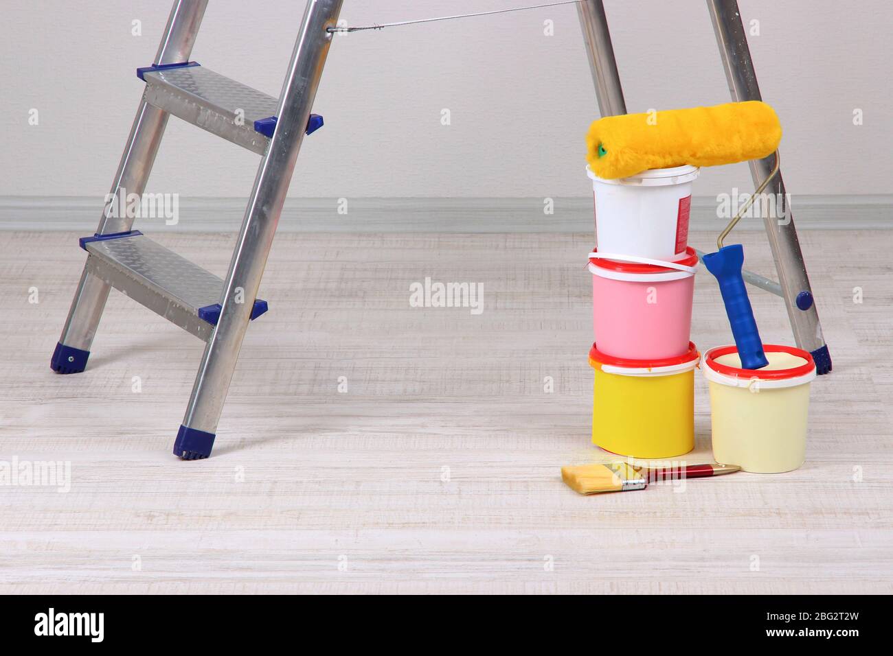 Metal ladder and paint in room Stock Photo - Alamy