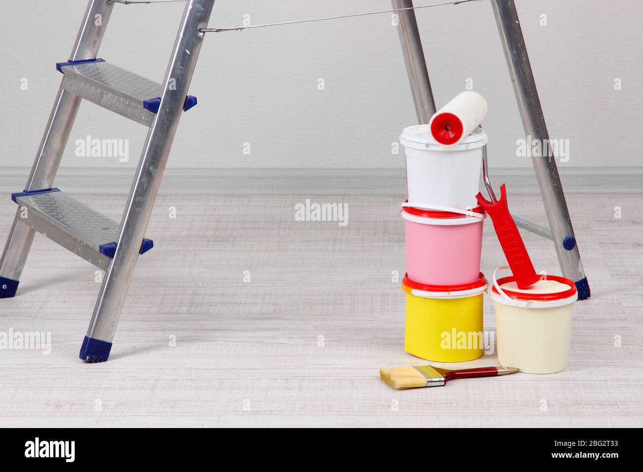 Metal ladder and paint in room Stock Photo - Alamy