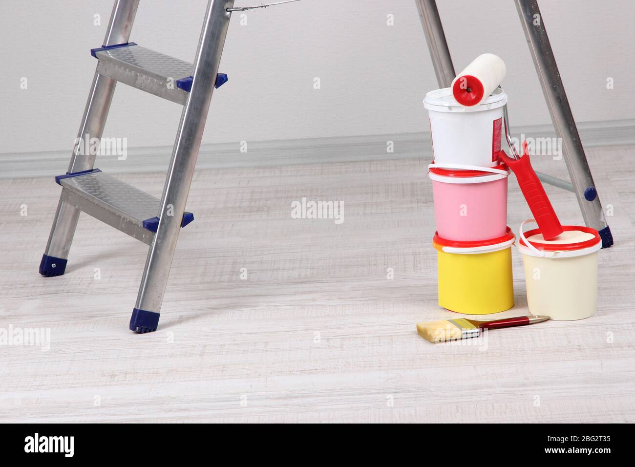 Metal ladder and paint in room Stock Photo - Alamy