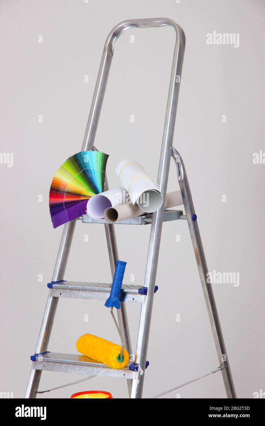 Metal ladder and paint in room Stock Photo - Alamy