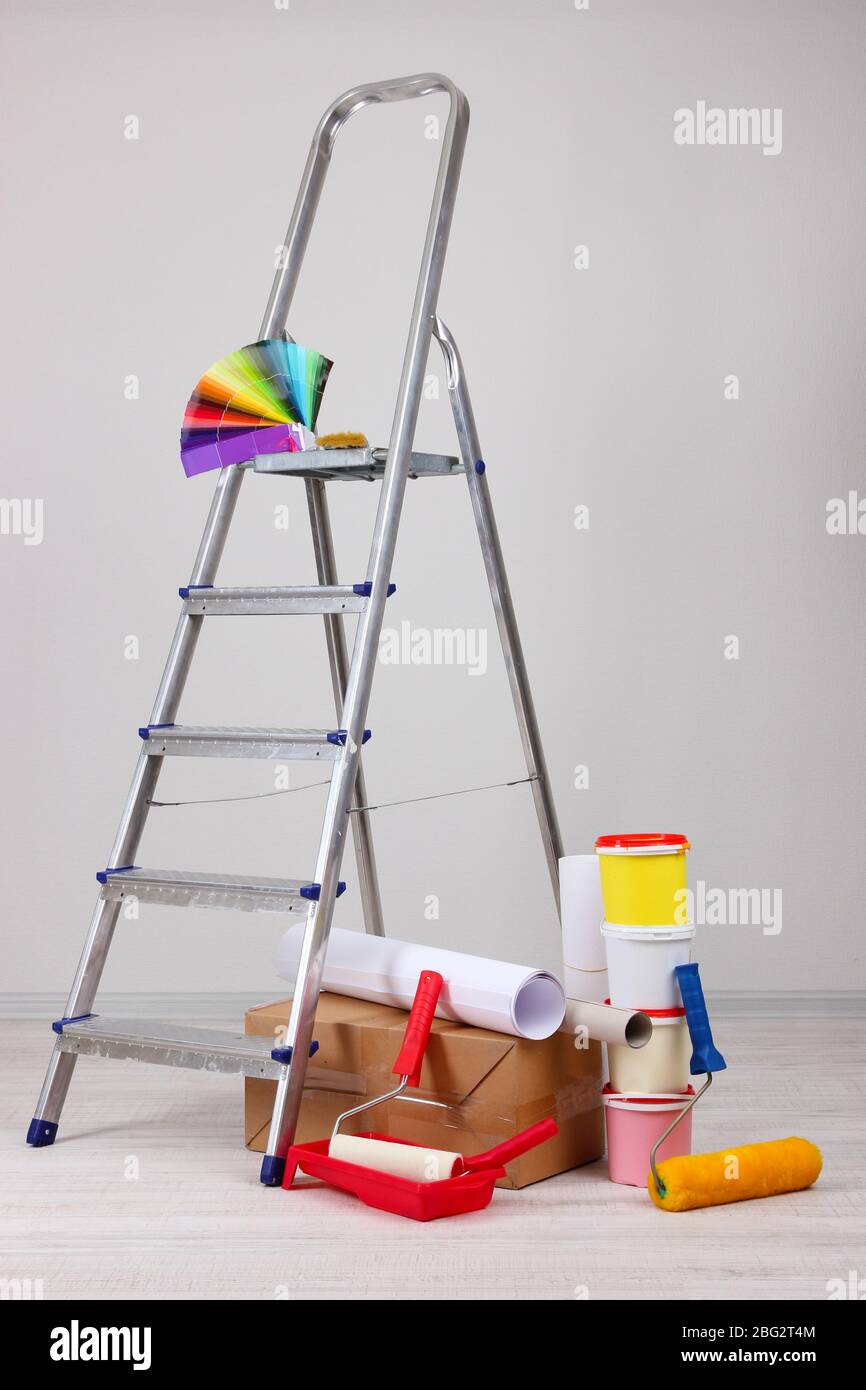 Metal ladder and paint in room Stock Photo - Alamy