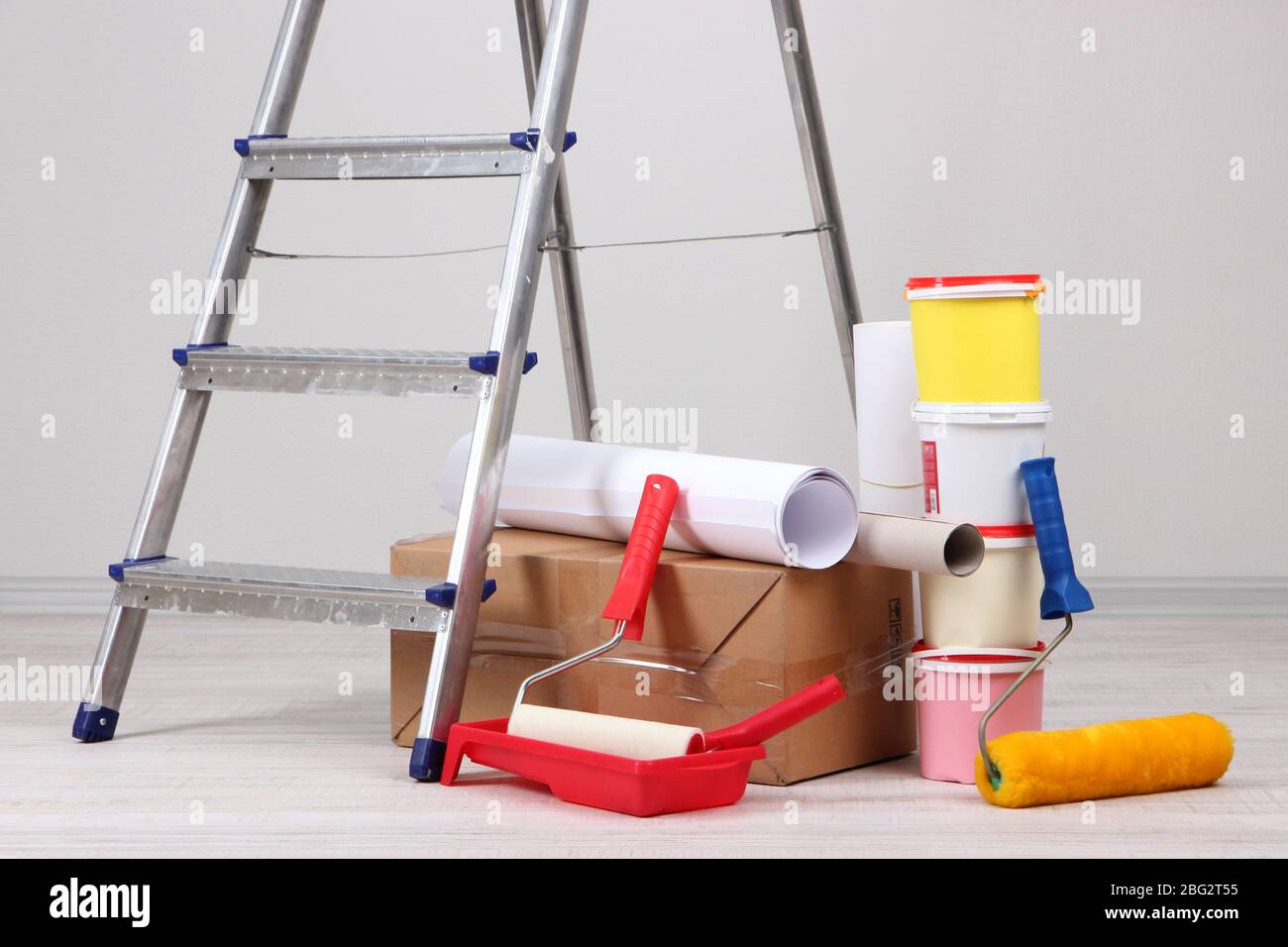 Metal ladder and paint in room Stock Photo - Alamy