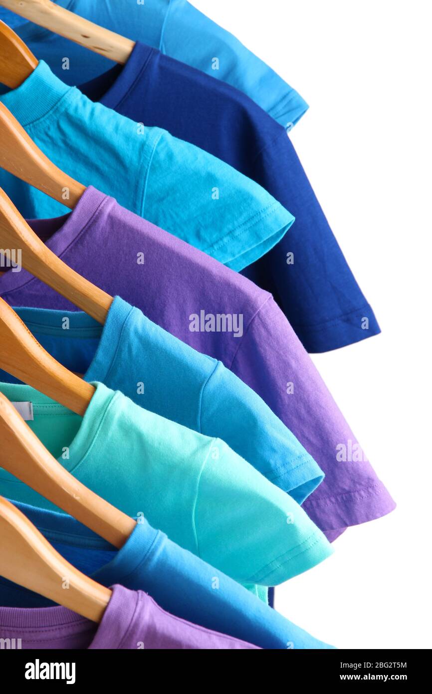 Lots of T-shirts on hangers isolated on white Stock Photo - Alamy