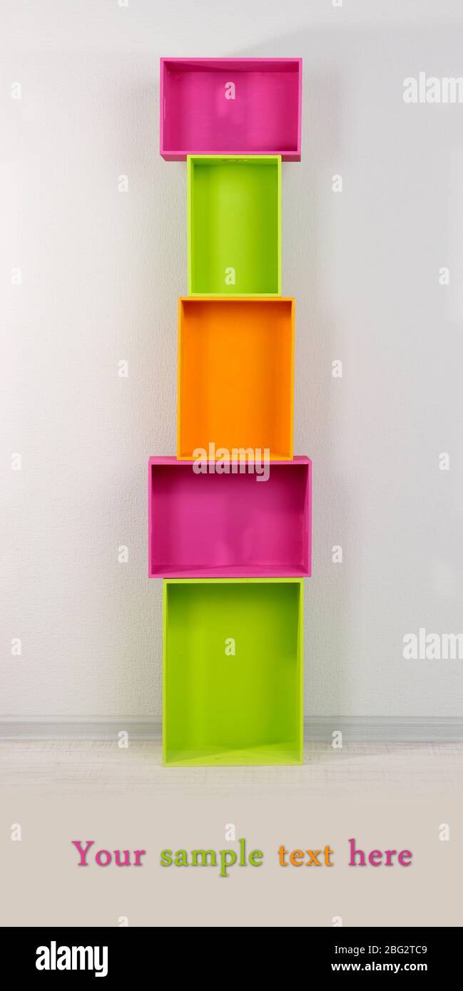 Beautiful colorful crates as shelves standing in room Stock Photo - Alamy