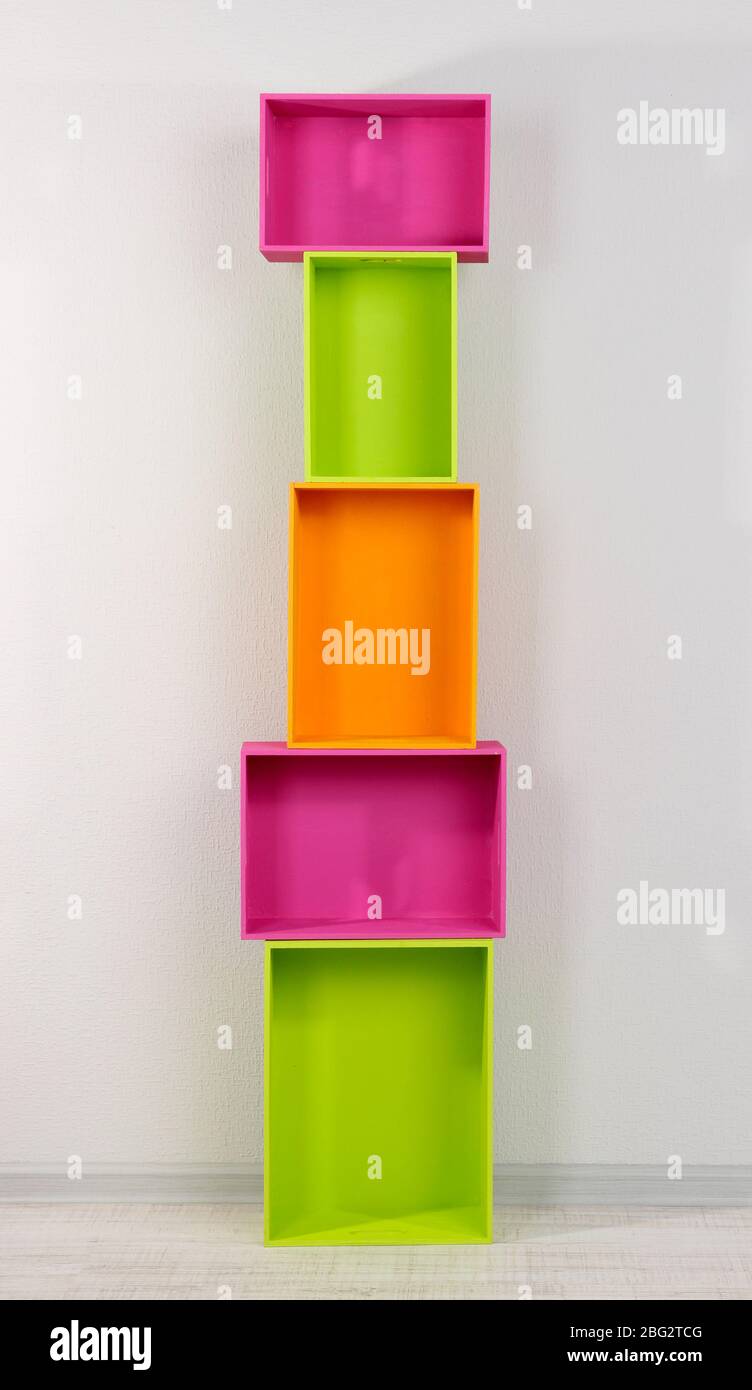 Beautiful colorful crates as shelves standing in room Stock Photo - Alamy