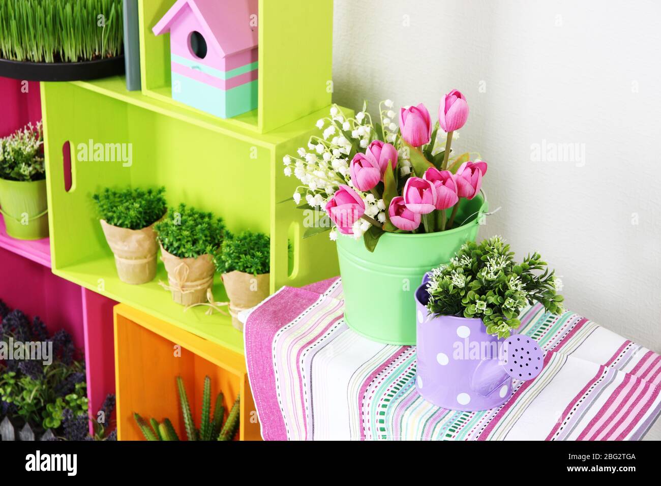 Colorful shelves and table with decorative elements and flowers Stock ...