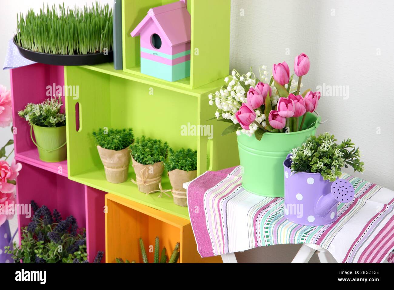 Colorful shelves and table with decorative elements and flowers Stock ...
