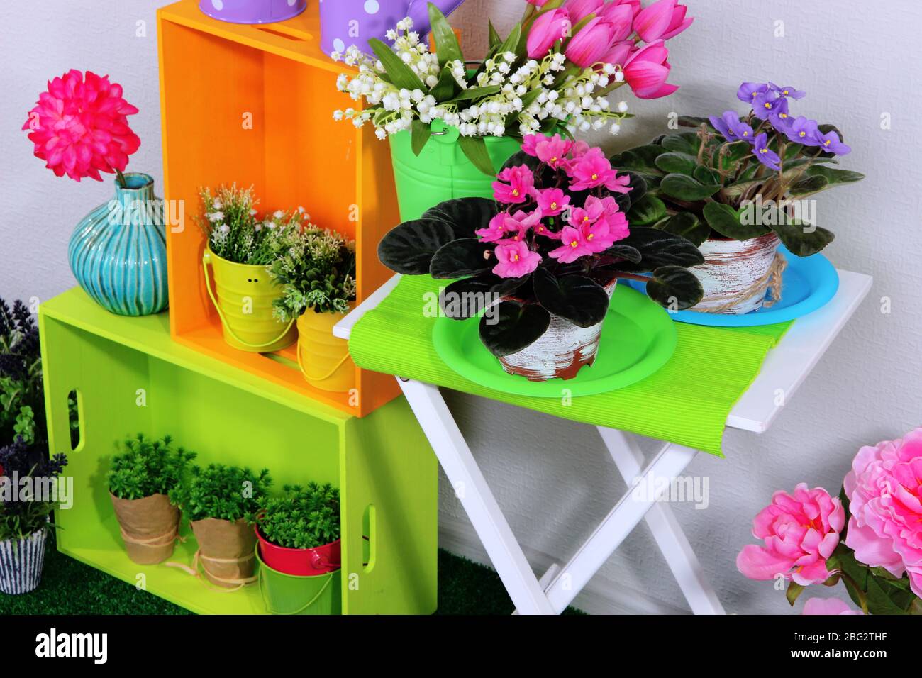 Colorful shelves and table with decorative elements and flowers Stock ...