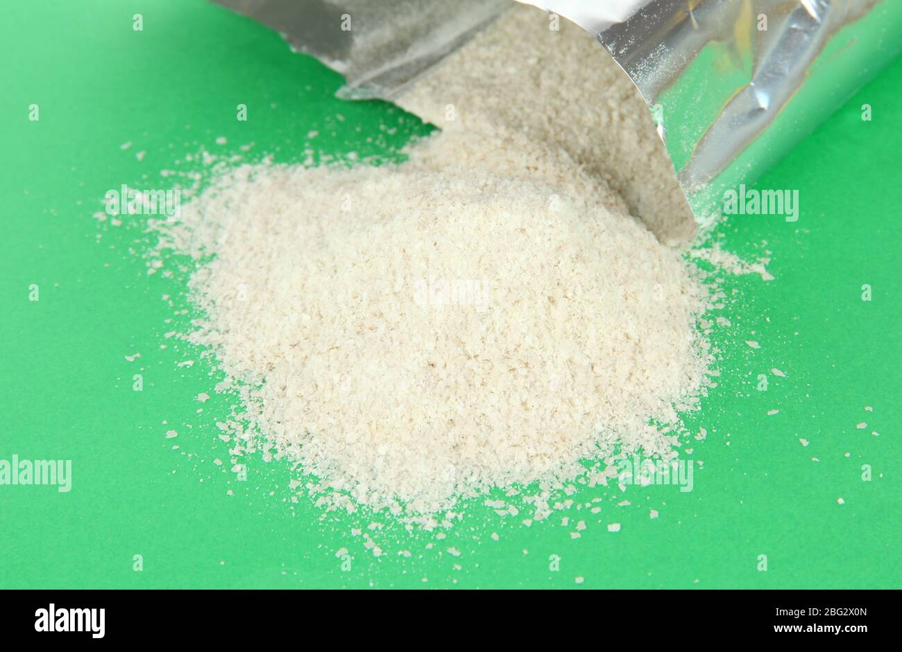 Powdered milk for baby on green background Stock Photo - Alamy