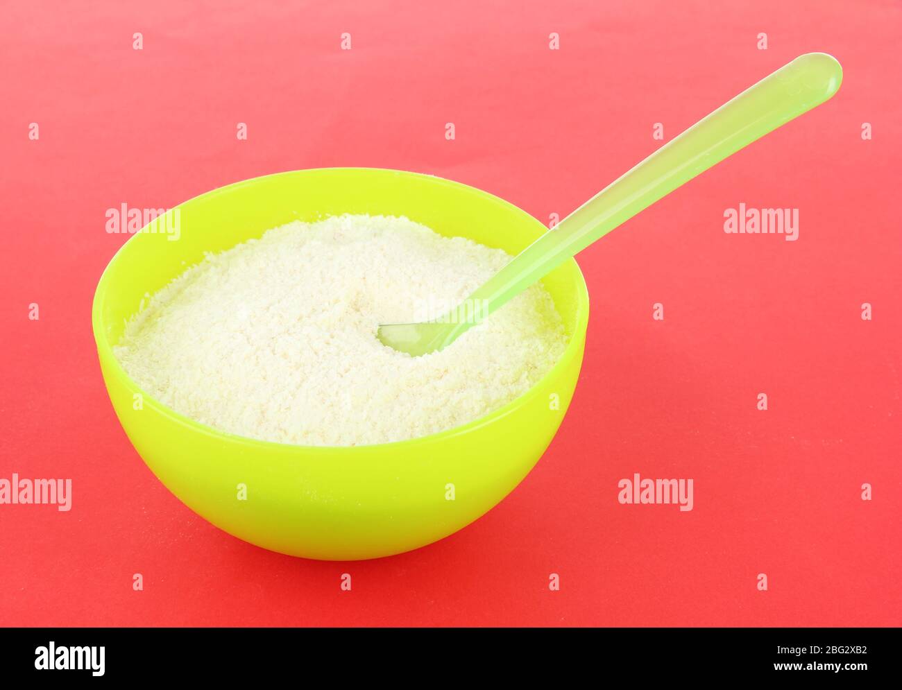 Powdered milk in bowl for baby and spoon on red background Stock Photo ...