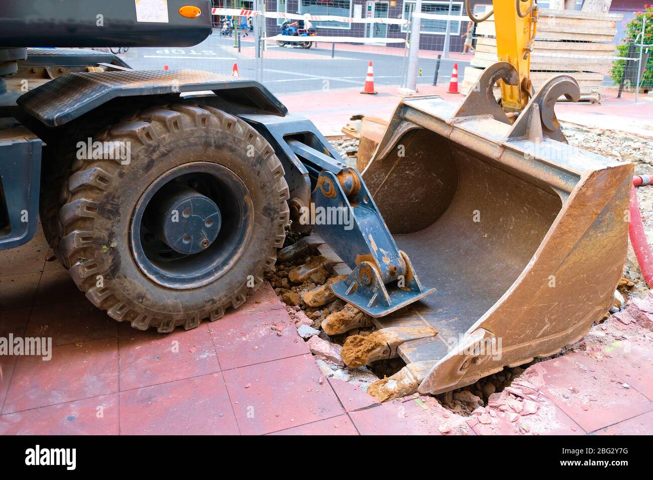 Heavy road building machinery, fore wheel, big tyre and a loader bucket ...