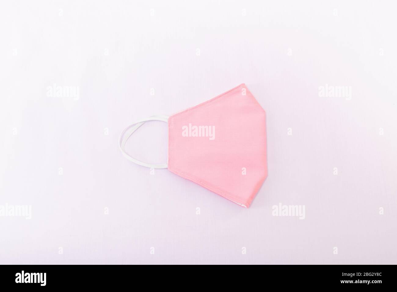 The pink clothes mask on white background Stock Photo - Alamy
