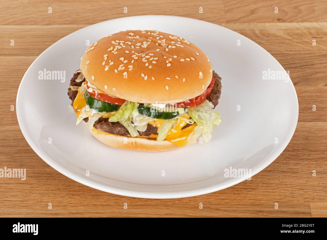Tasty cheeseburger on wooden background Stock Photo - Alamy