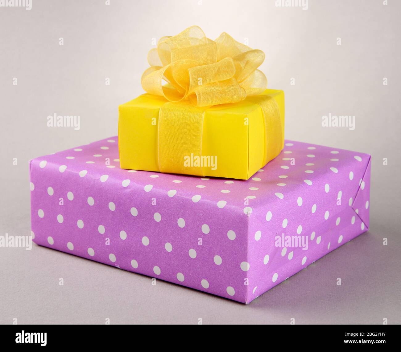 Bright gifts with bows on grey background Stock Photo - Alamy