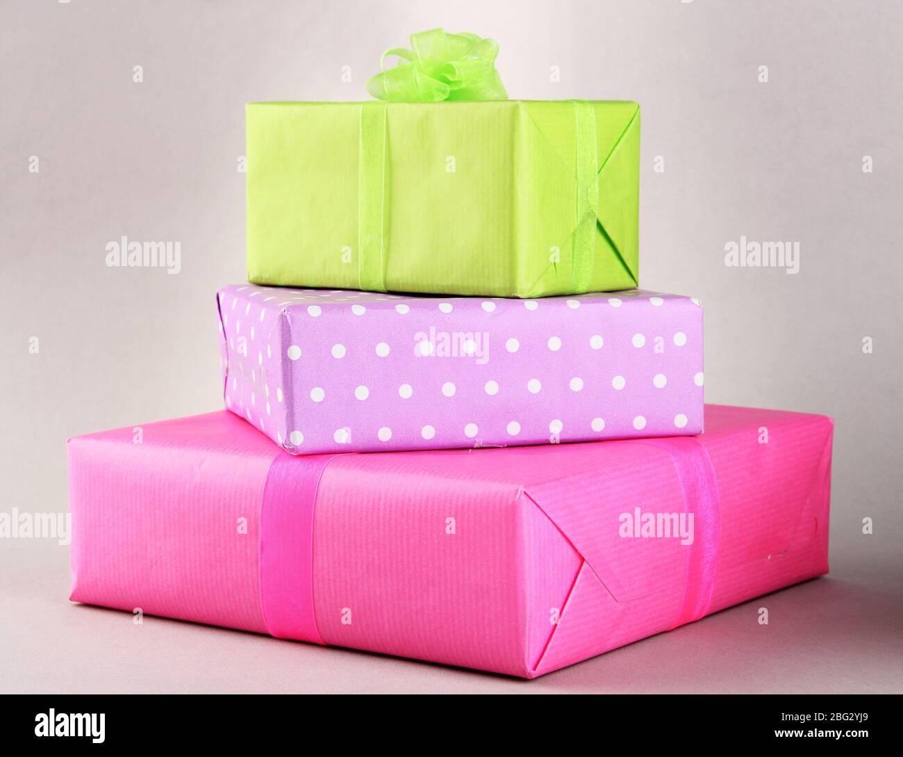 Bright gifts with bows on grey background Stock Photo - Alamy