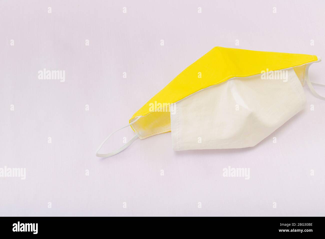 The yellow clothes mask on white background Stock Photo - Alamy