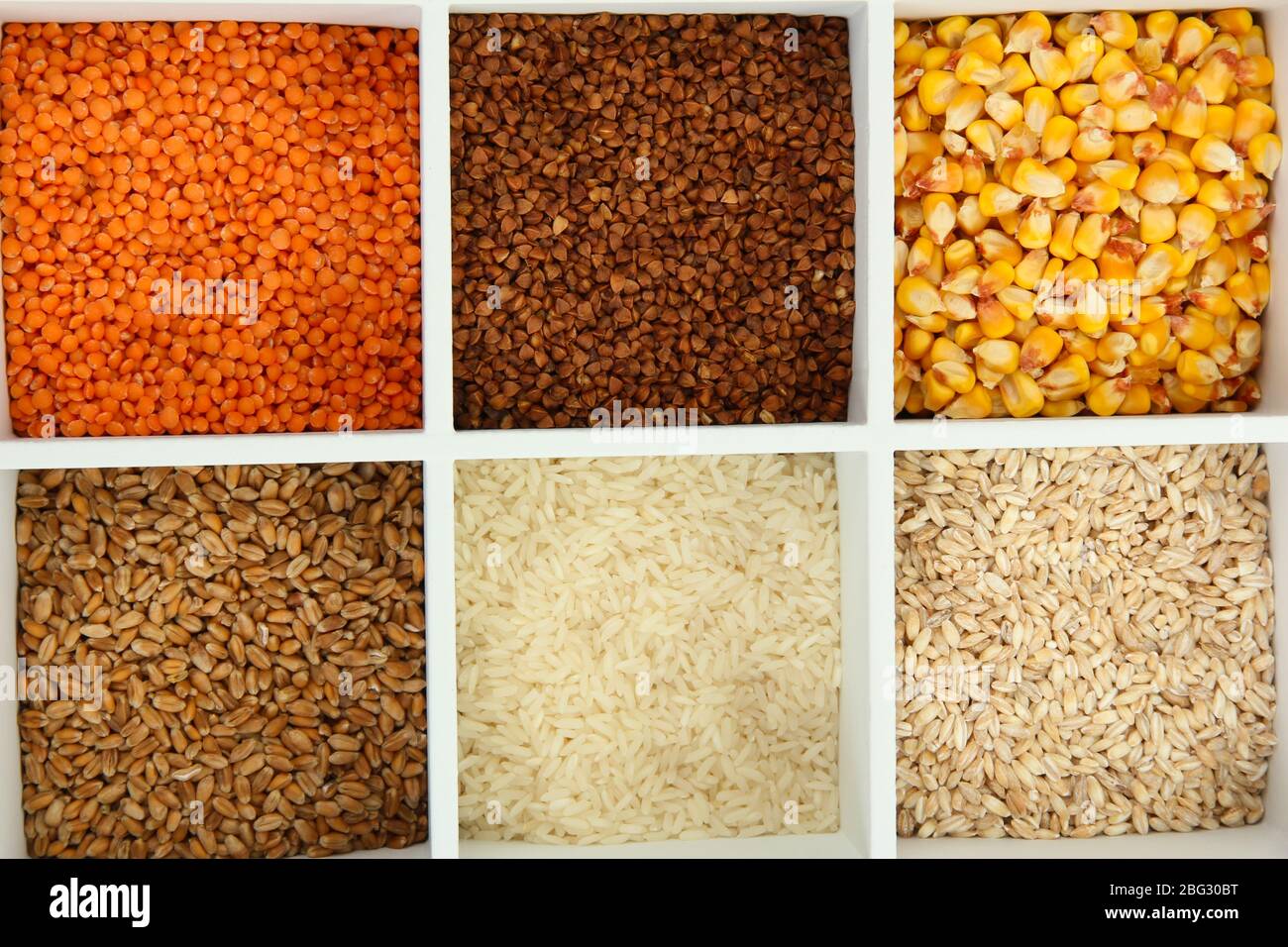 Assortment of cereals in white wooden box close up Stock Photo - Alamy
