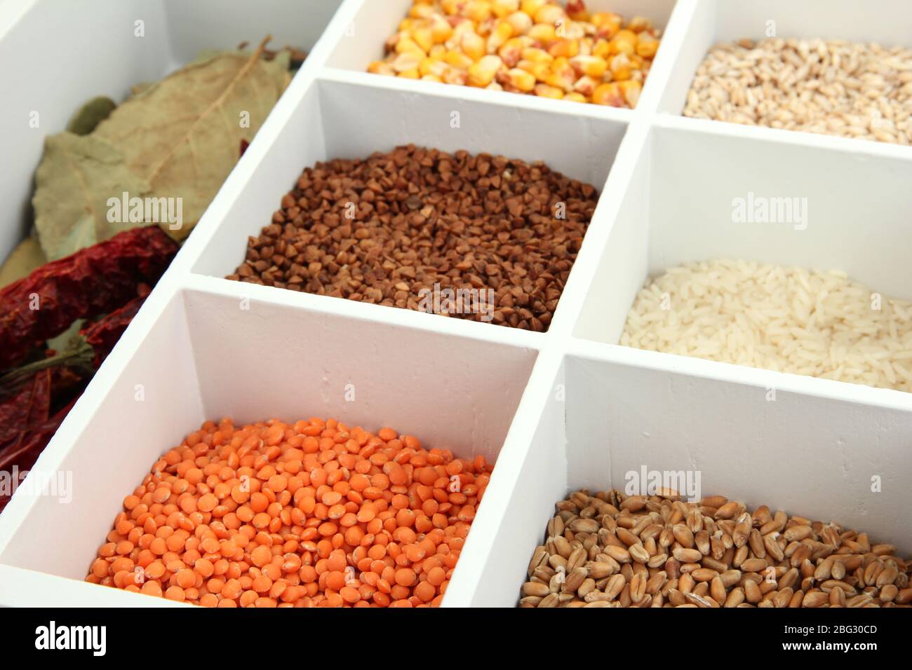 Assortment of cereals in white wooden box close up Stock Photo - Alamy