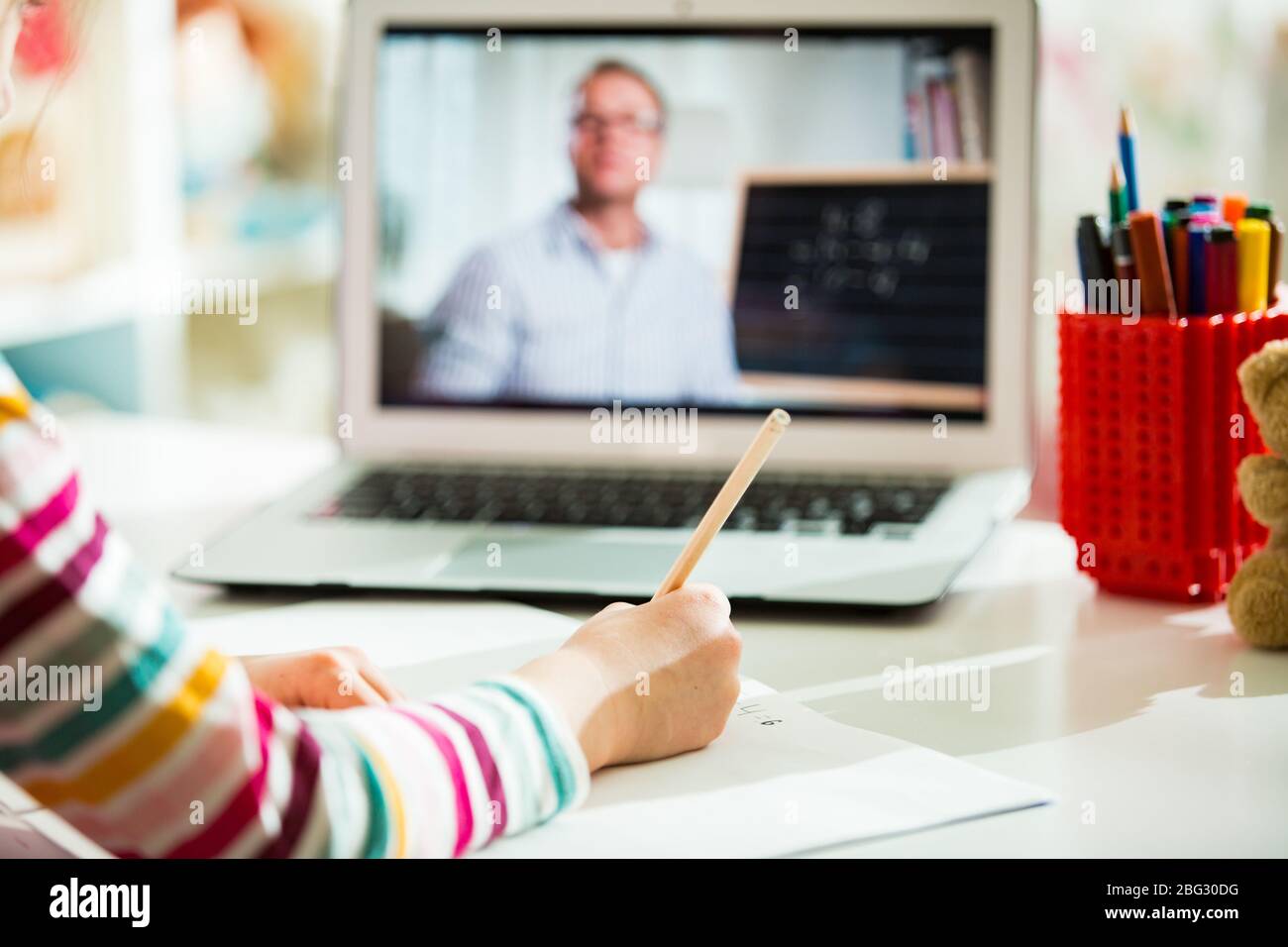 Middle-aged distance teacher having video conference call with pupil ...