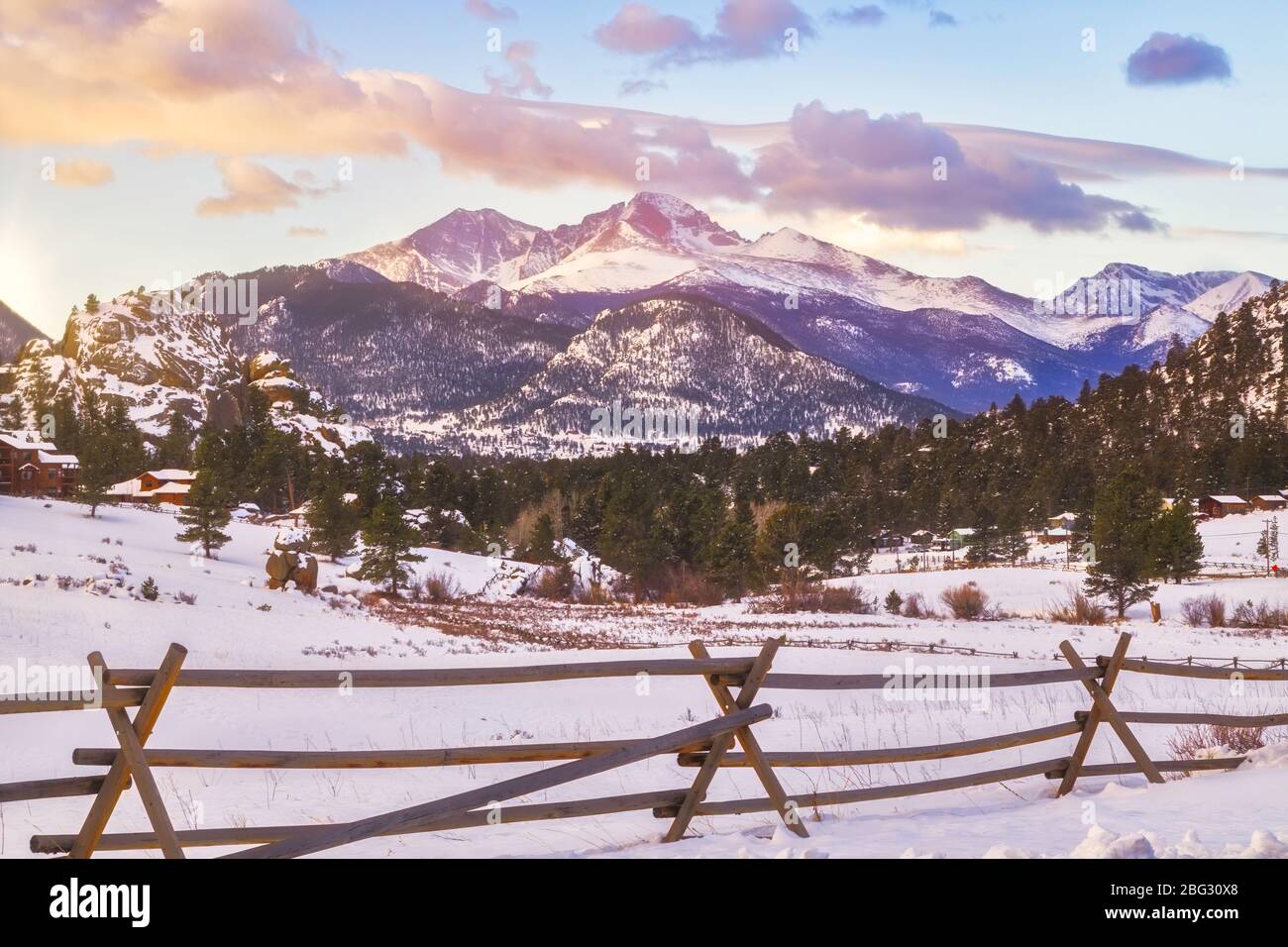 The summit of Longs Peak glows at sunrise after a fresh snowfall in ...
