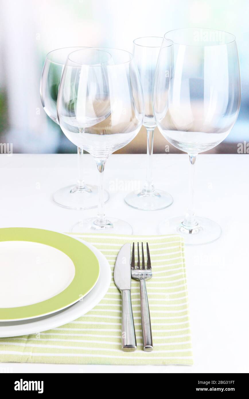 Table setting with glasses for different drinks on table on room ...