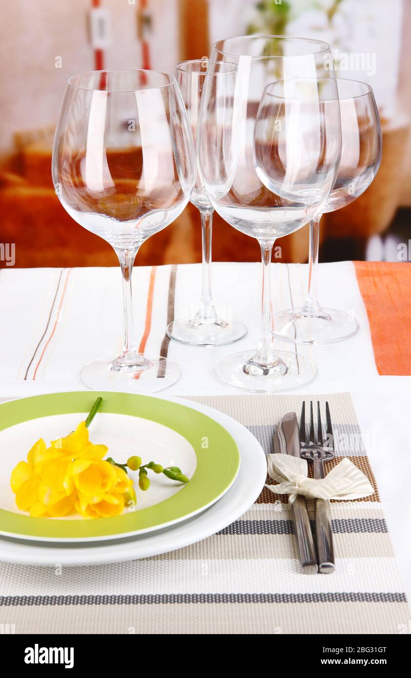 Table setting with glasses for different drinks on table on room ...