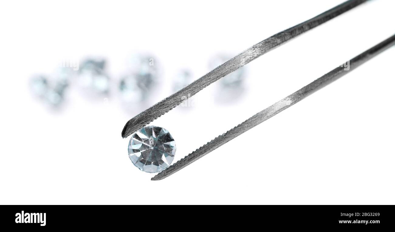 Beautiful shining crystal (diamond) in the tweezers, isolated on white ...