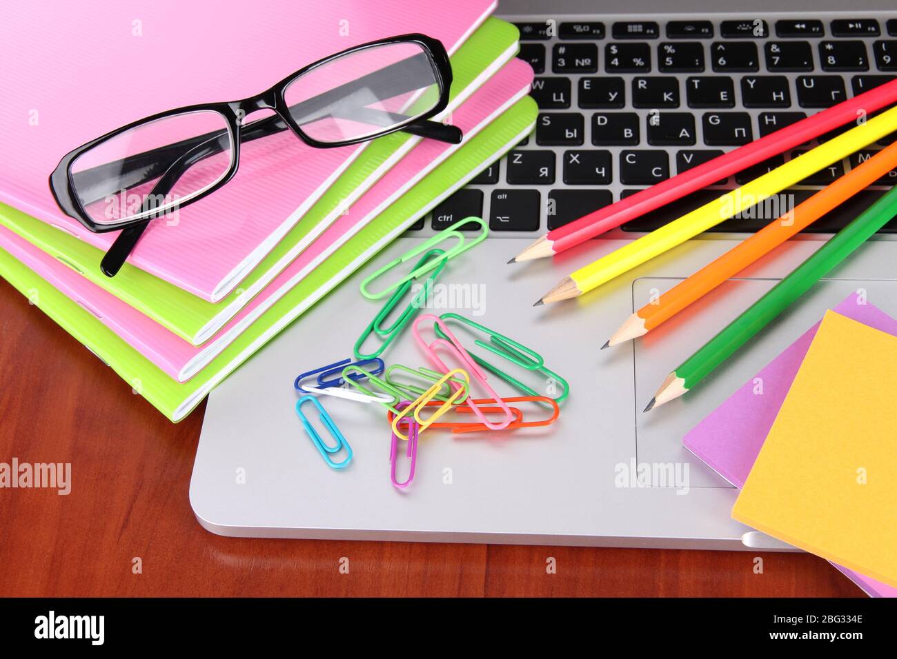 Laptop with stationery on table Stock Photo - Alamy