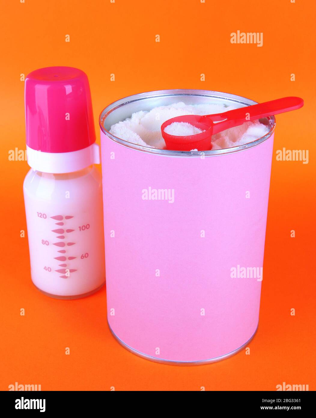 Powdered milk with baby bottle of milk on orange background Stock Photo ...