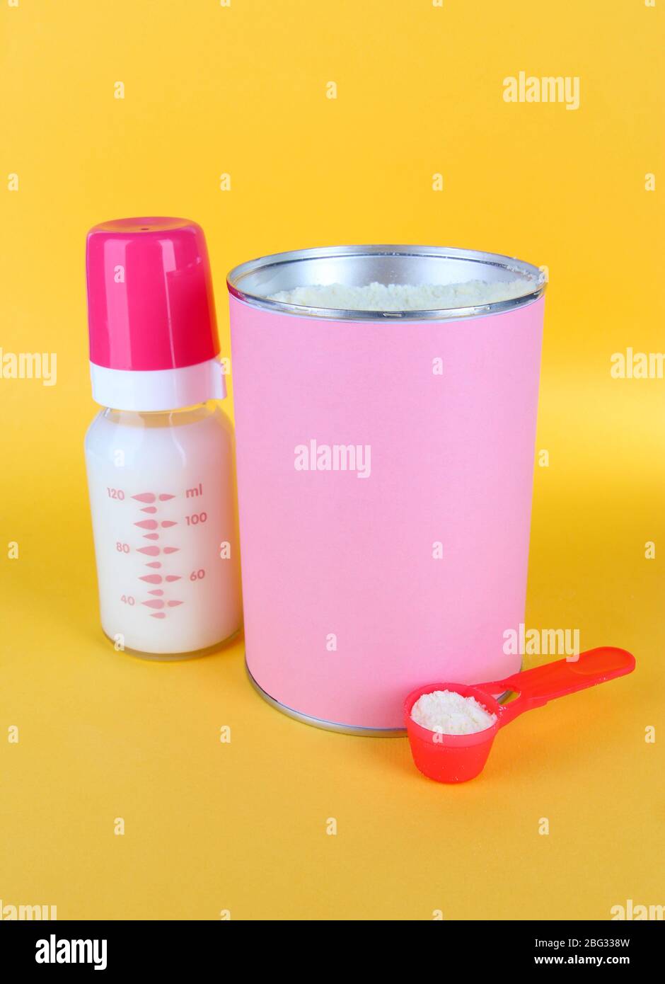 Powdered milk with baby bottle of milk on yellow background Stock Photo ...