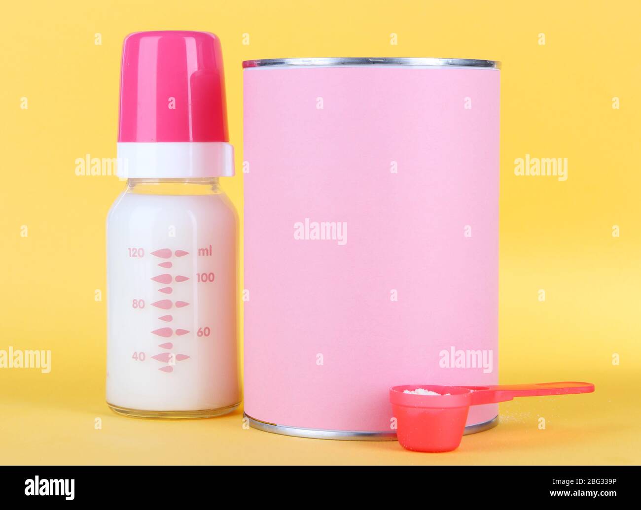Powdered milk with baby bottle of milk on yellow background Stock Photo ...