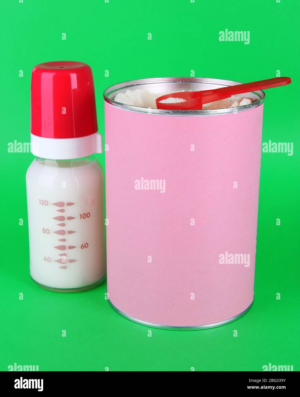Powdered milk with baby bottle of milk on green background Stock Photo ...