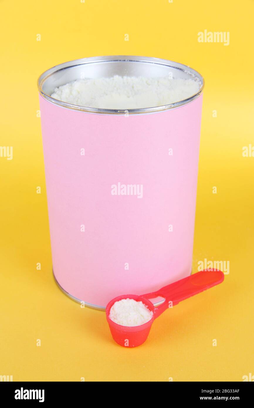 Powdered milk for baby on yellow background Stock Photo - Alamy