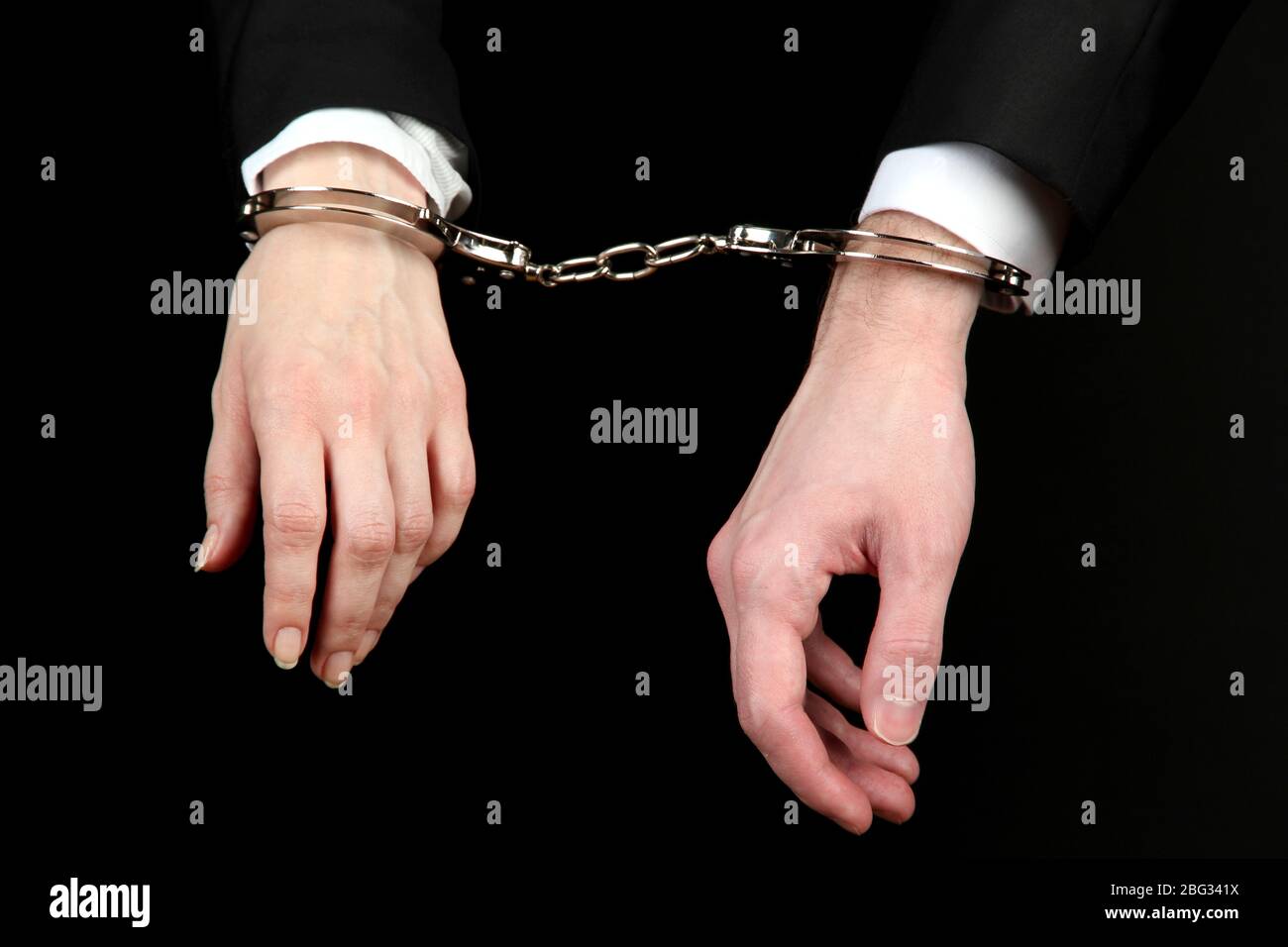 Man and woman hands and breaking handcuffs isolated on black background ...