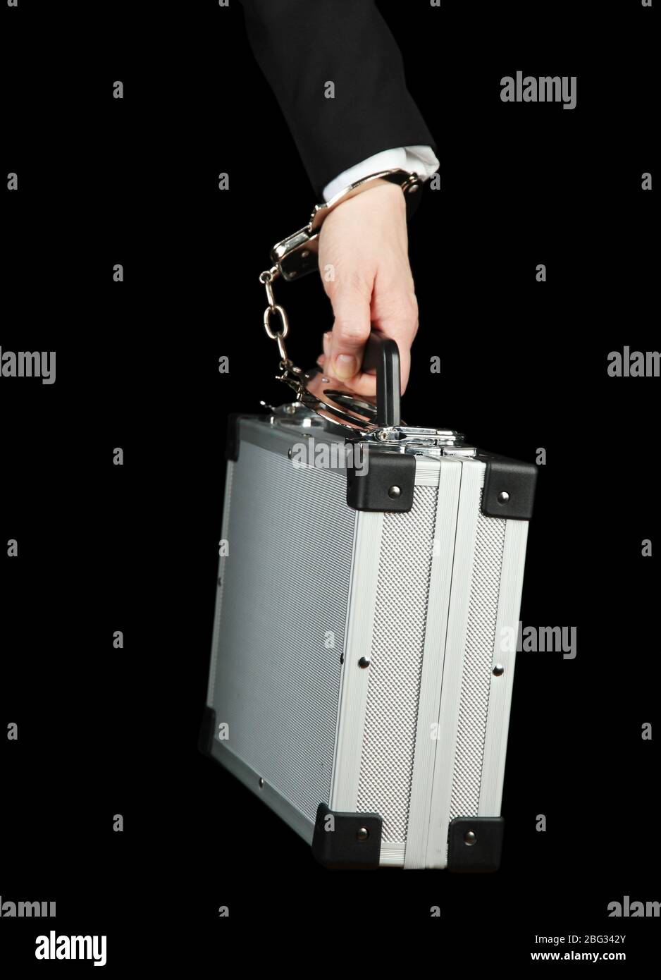 Hand with handcuff and suitcase, isolated on black Stock Photo - Alamy