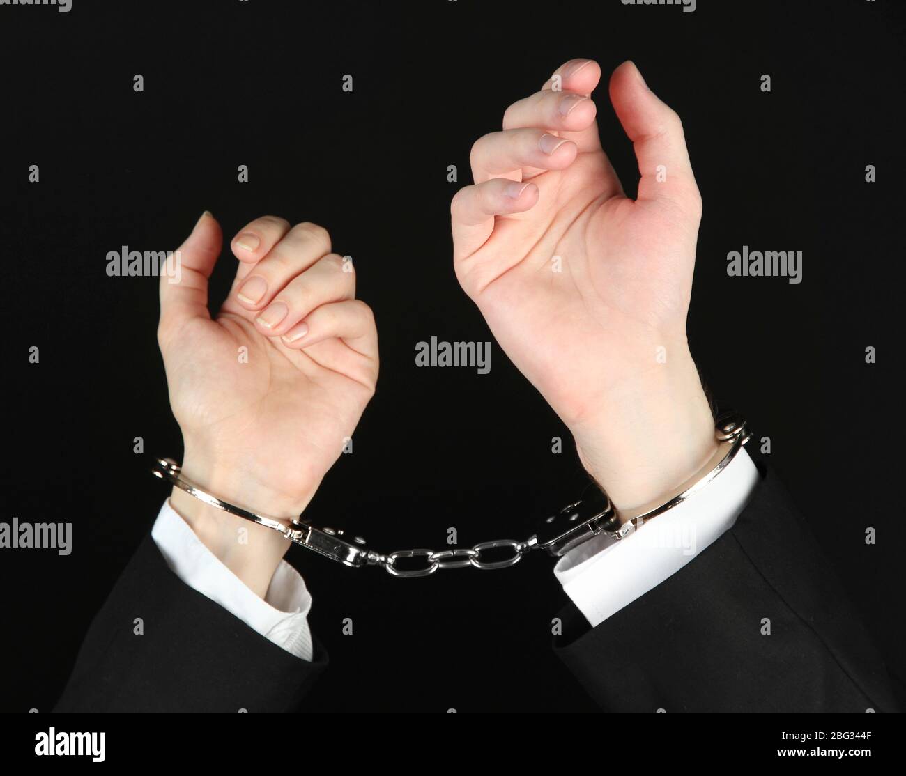Man and woman hands and breaking handcuffs isolated on black background ...