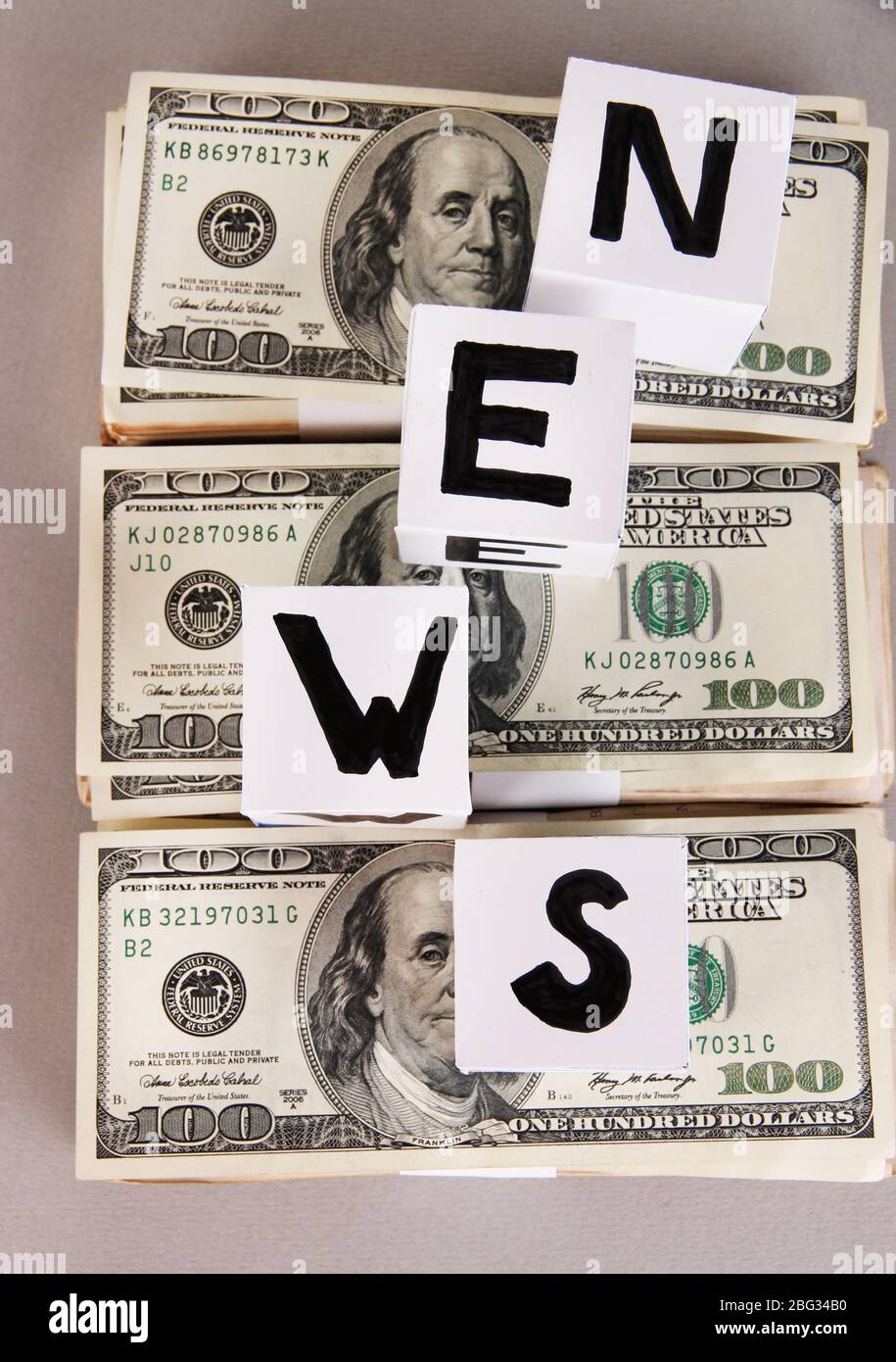 White paper cubes labeled "News" with money on grey background Stock ...