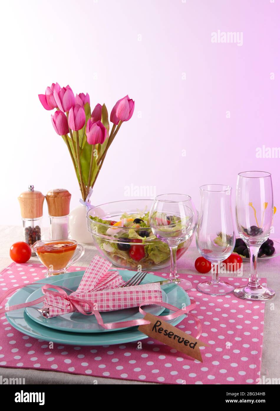 Table setting on pink background Stock Photo - Alamy